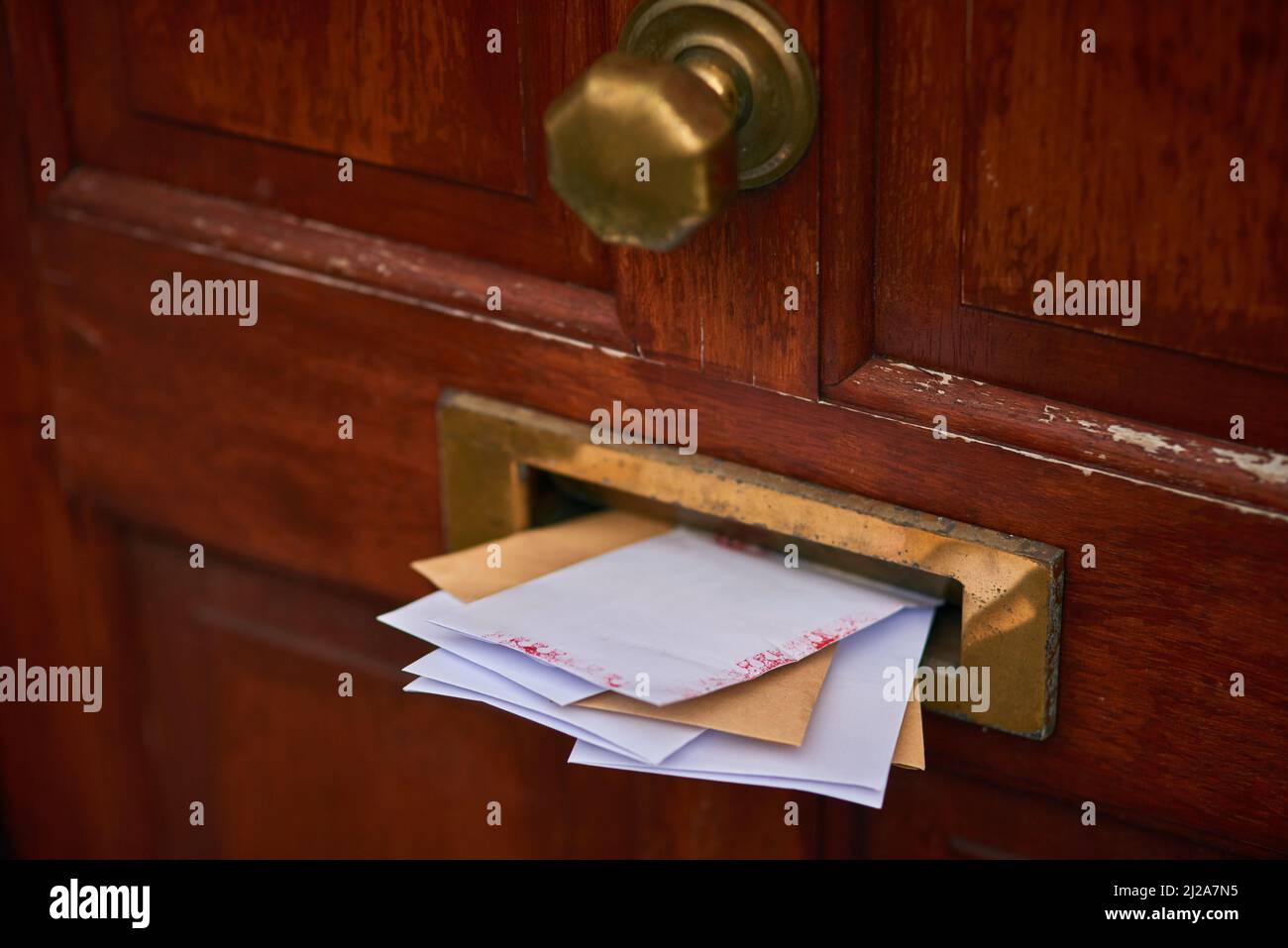 Youve got mail. Cropped shot of letters in a letter box Stock Photo - Alamy