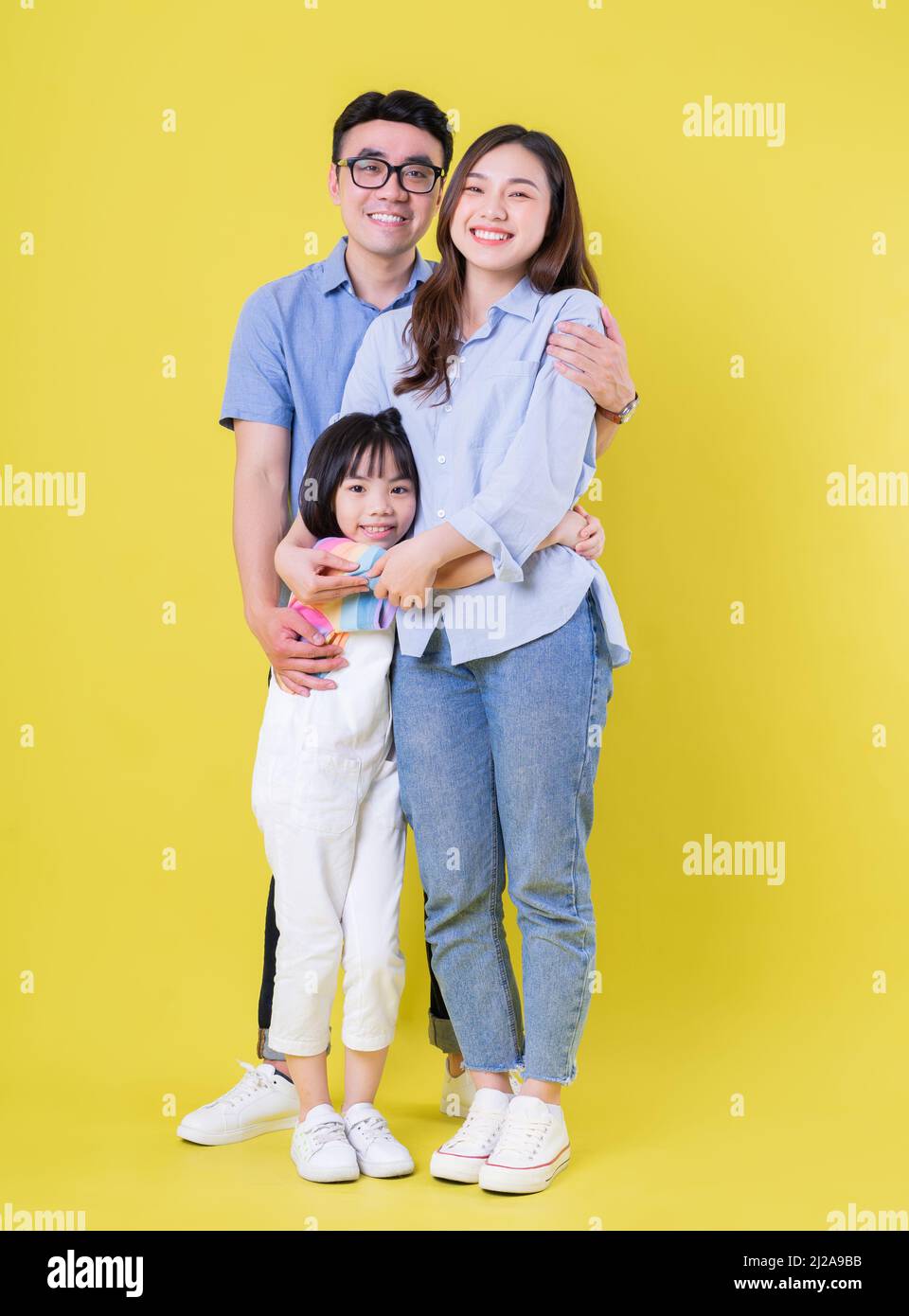 Full length image of young Asian family on background Stock Photo - Alamy