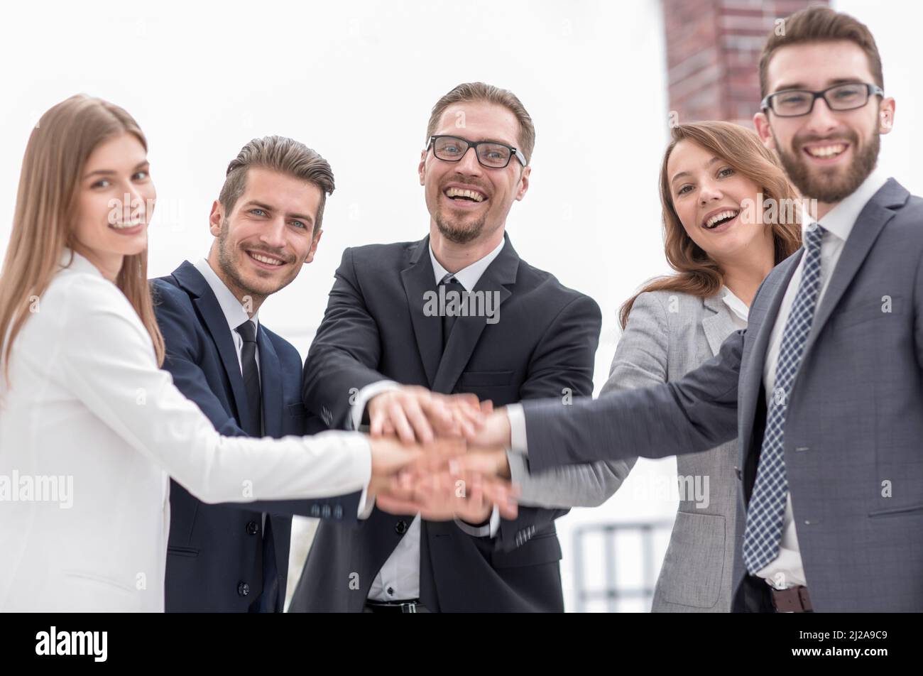 Business team showing unity with their hands together Stock Photo - Alamy