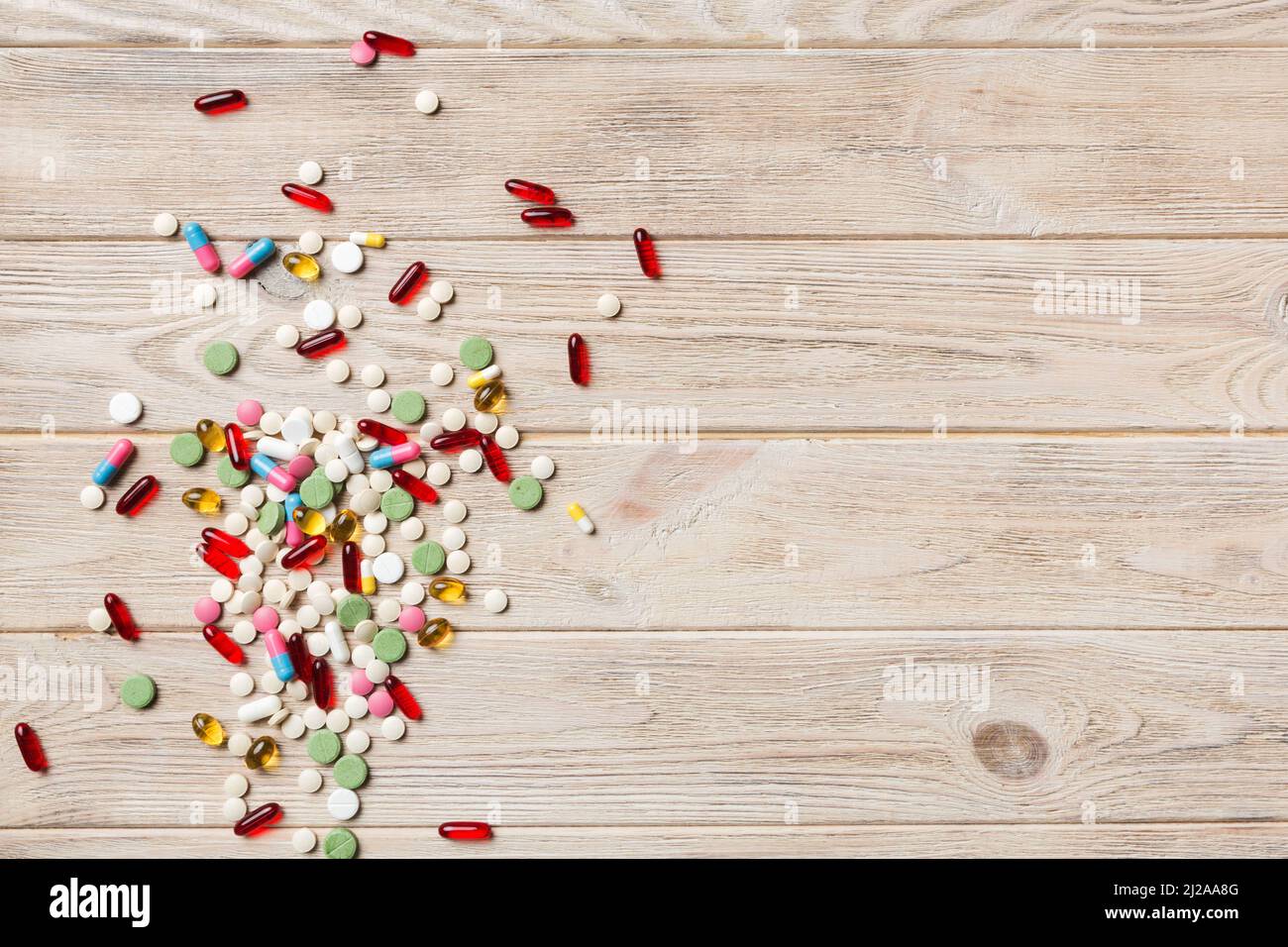 assorted pills and tablets top border over colored background. Many ...