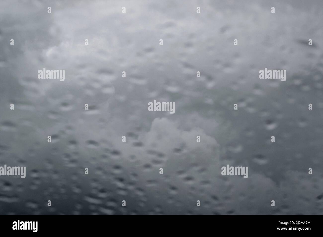 View through a car window parked on the coast on a wild stormy grey and ...