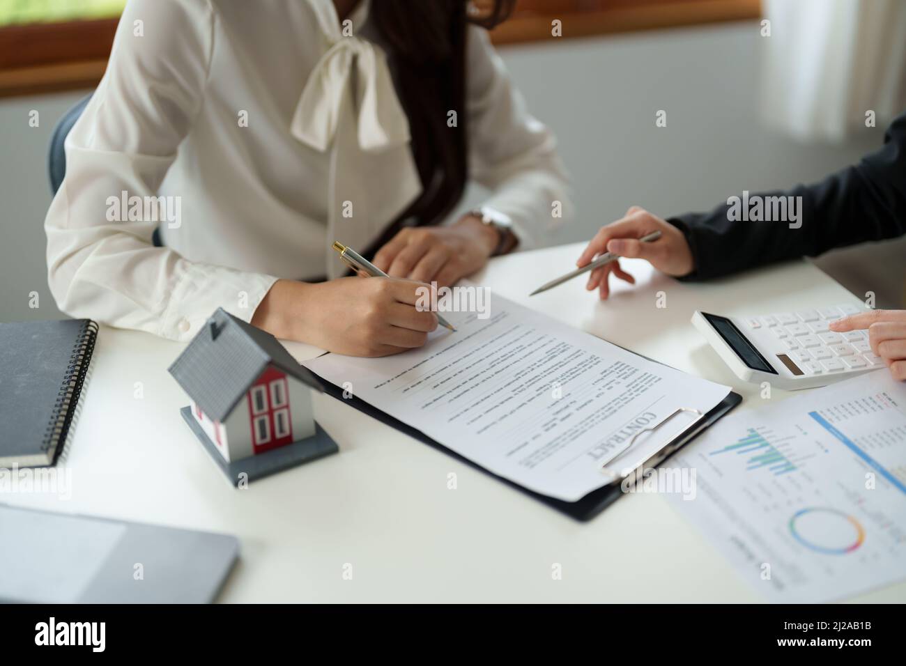 experienced real estate agent showing house model to client and ready ...