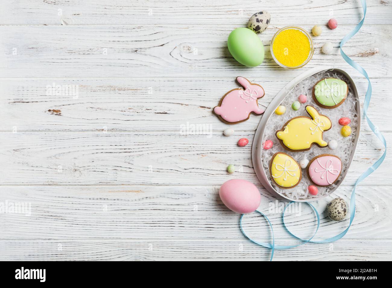 Colorful easter cookies in basket with Multi colors Easter eggs on ...