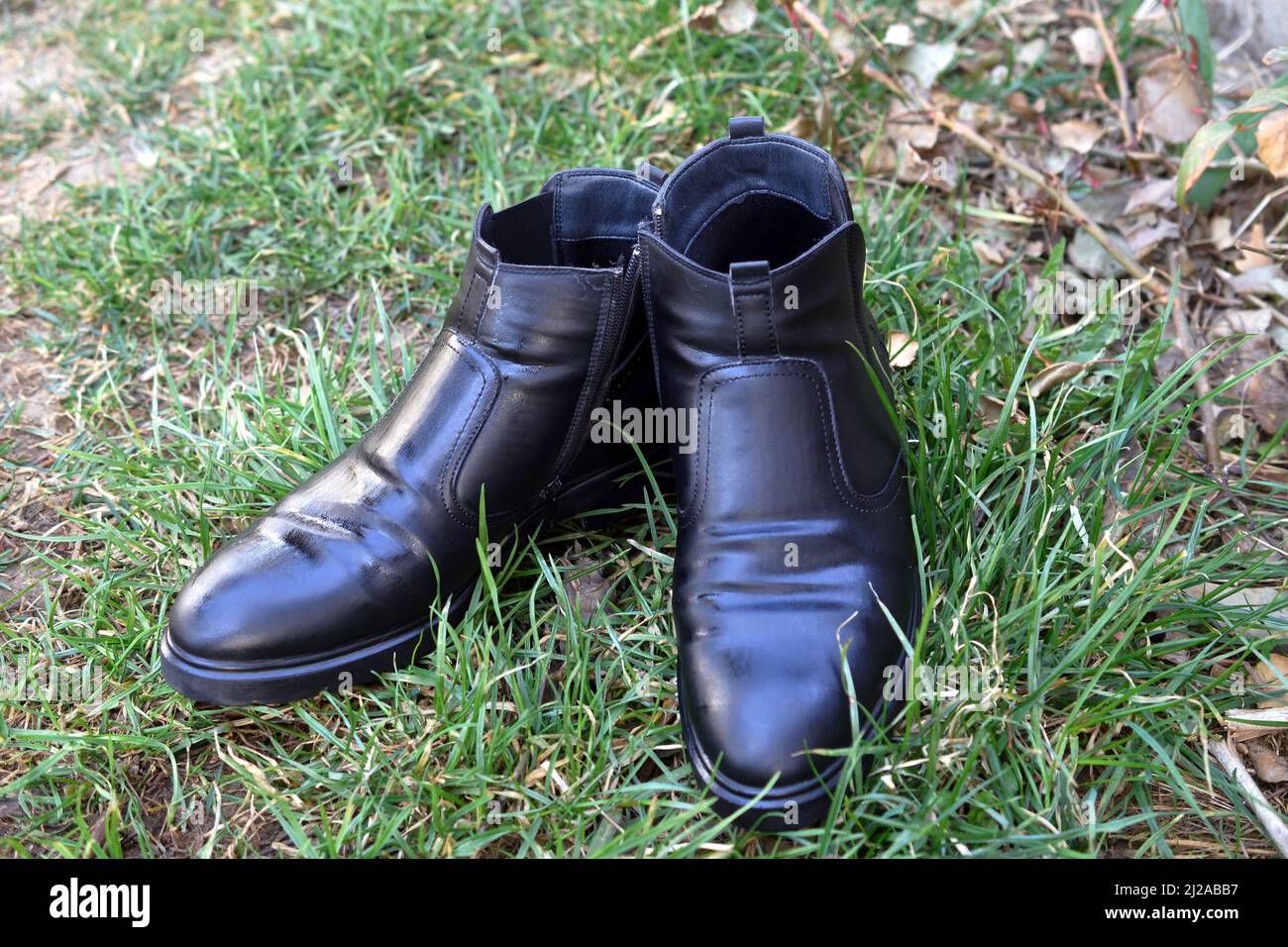 Just polished Shining black man's half boots Stock Photo - Alamy