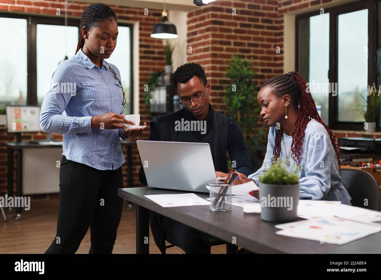 Financial company employees reviewing marketing strategy documentation ...