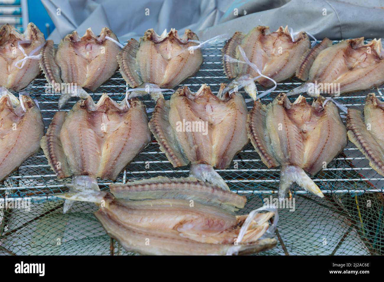 drying fish under sun in villages in Hong Kong, a traditional preserved ...
