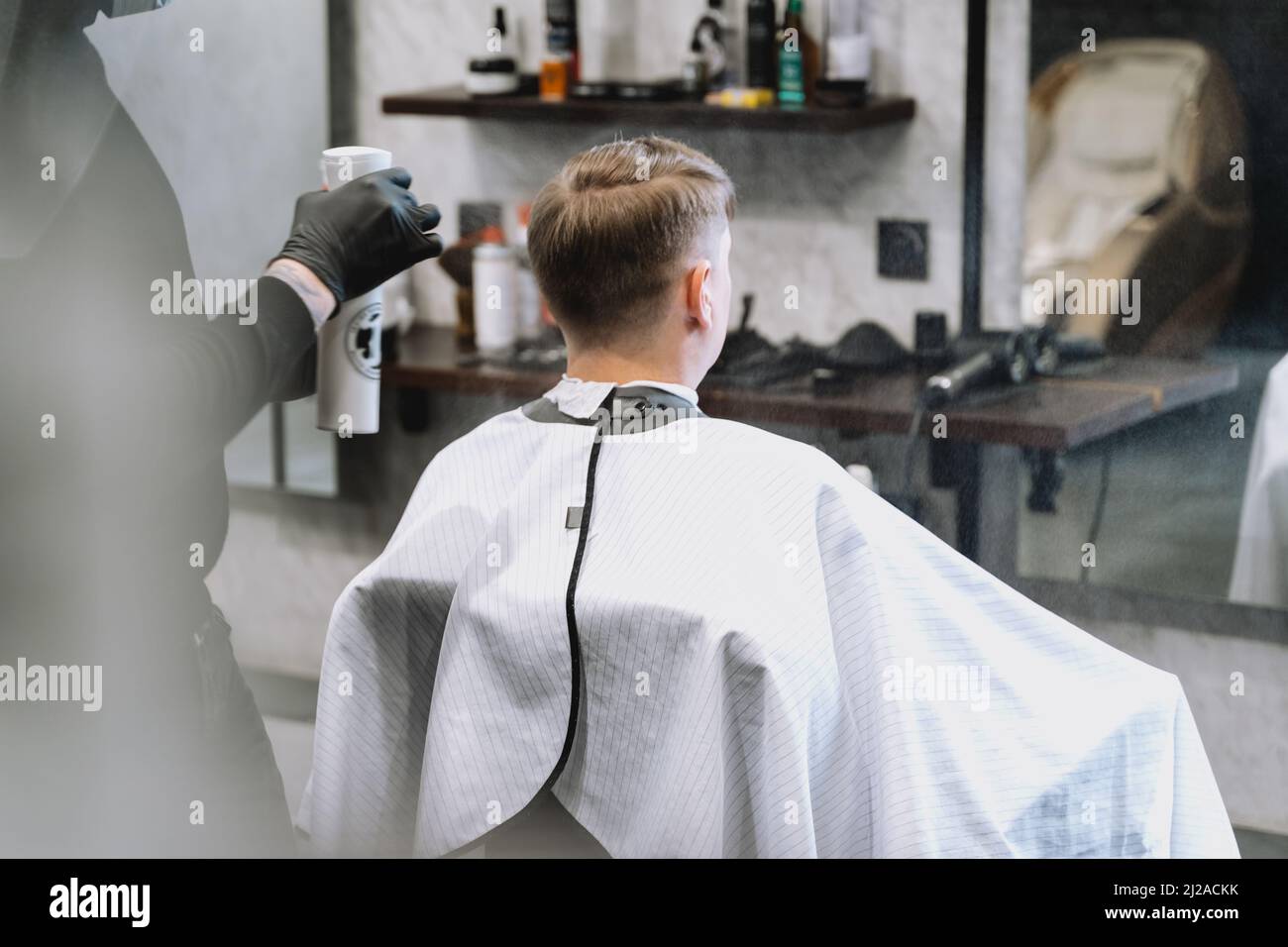 Visit to barbershop. Stylish man makes fashionable haircut. Barber ...