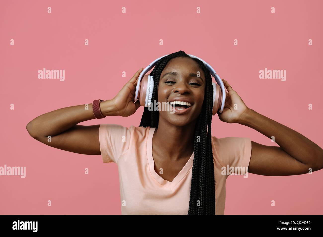 Beautiful young woman dancing and listening music in headphones chill ...