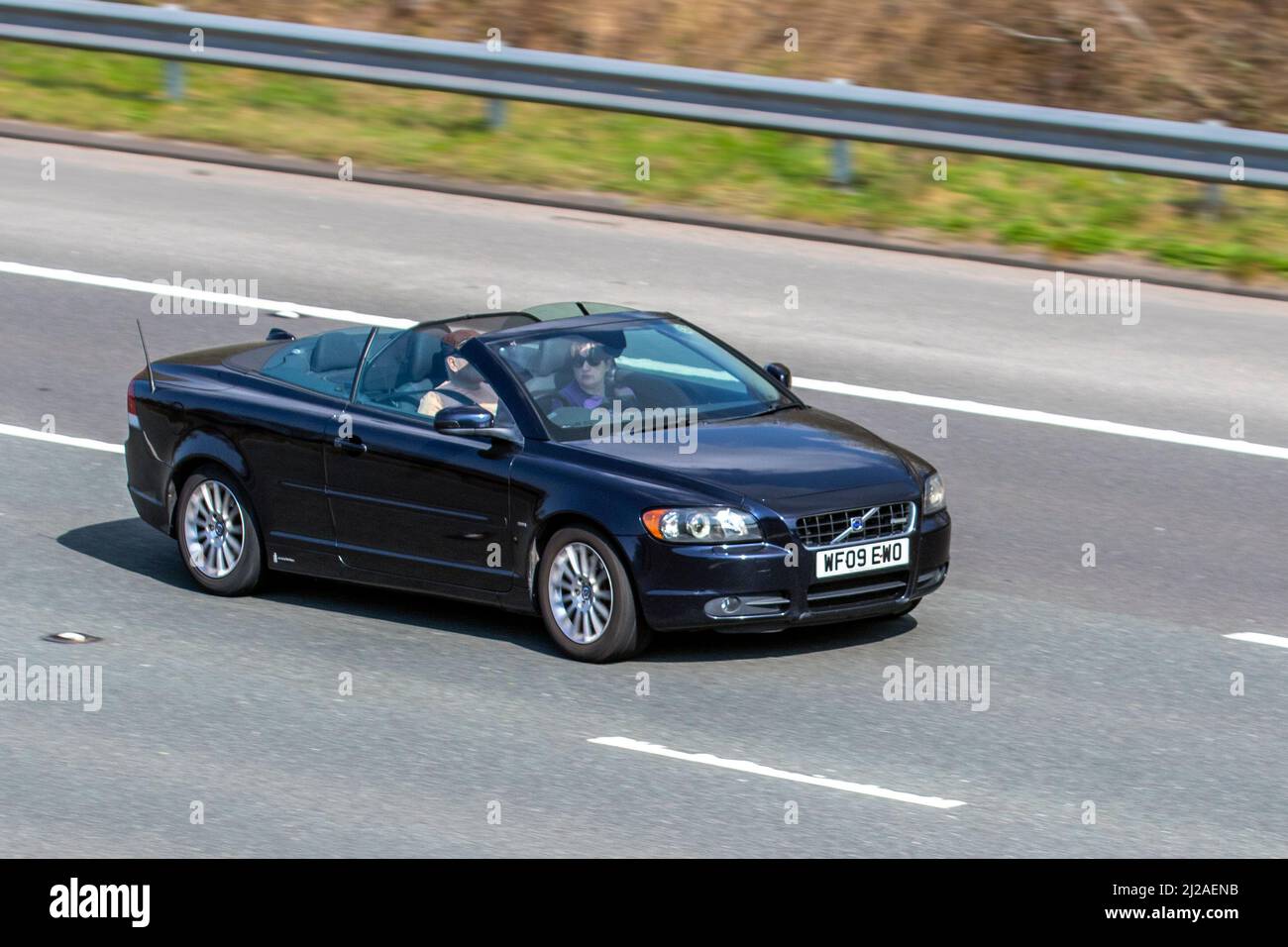 2009 blue Volvo C70 D S ( S TD) convertible driving on the M61 motorway ...