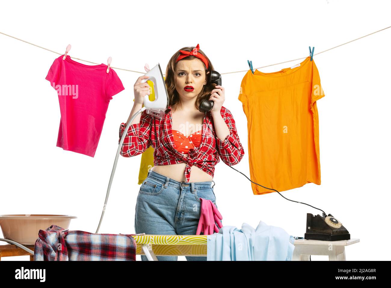 Laundry, cleaning, ironing. Beautiful housewife doing housework ...