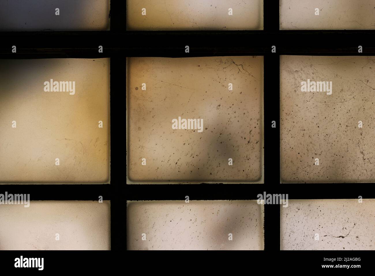 Old worn and stained translucent window with lots of build up of dirt ...