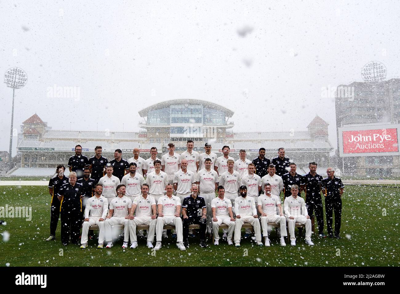 Nottinghamshire CCC pose for a team photograph as snow falls during a ...