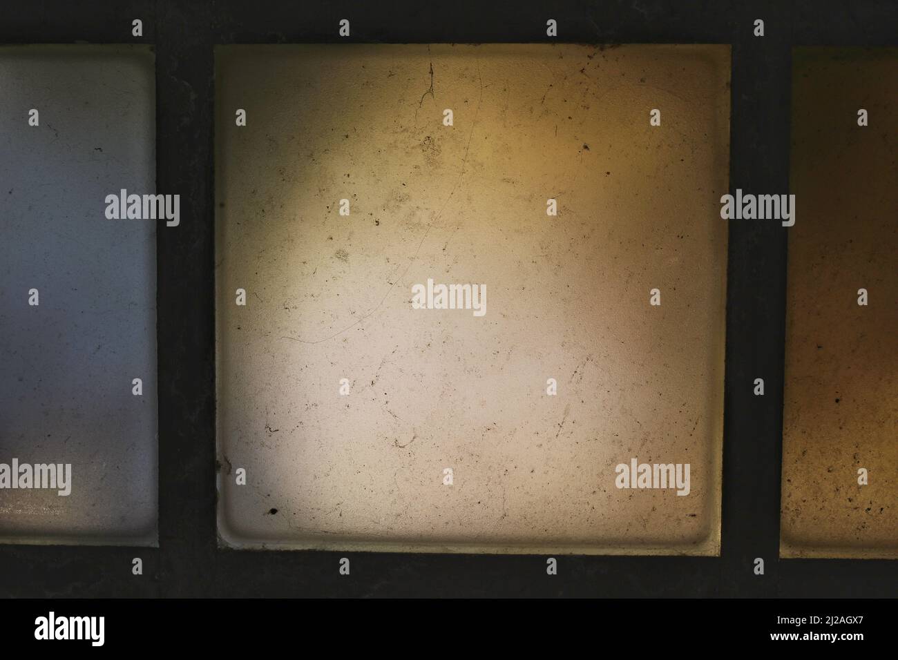 Old worn and stained translucent window with lots of build up of dirt ...