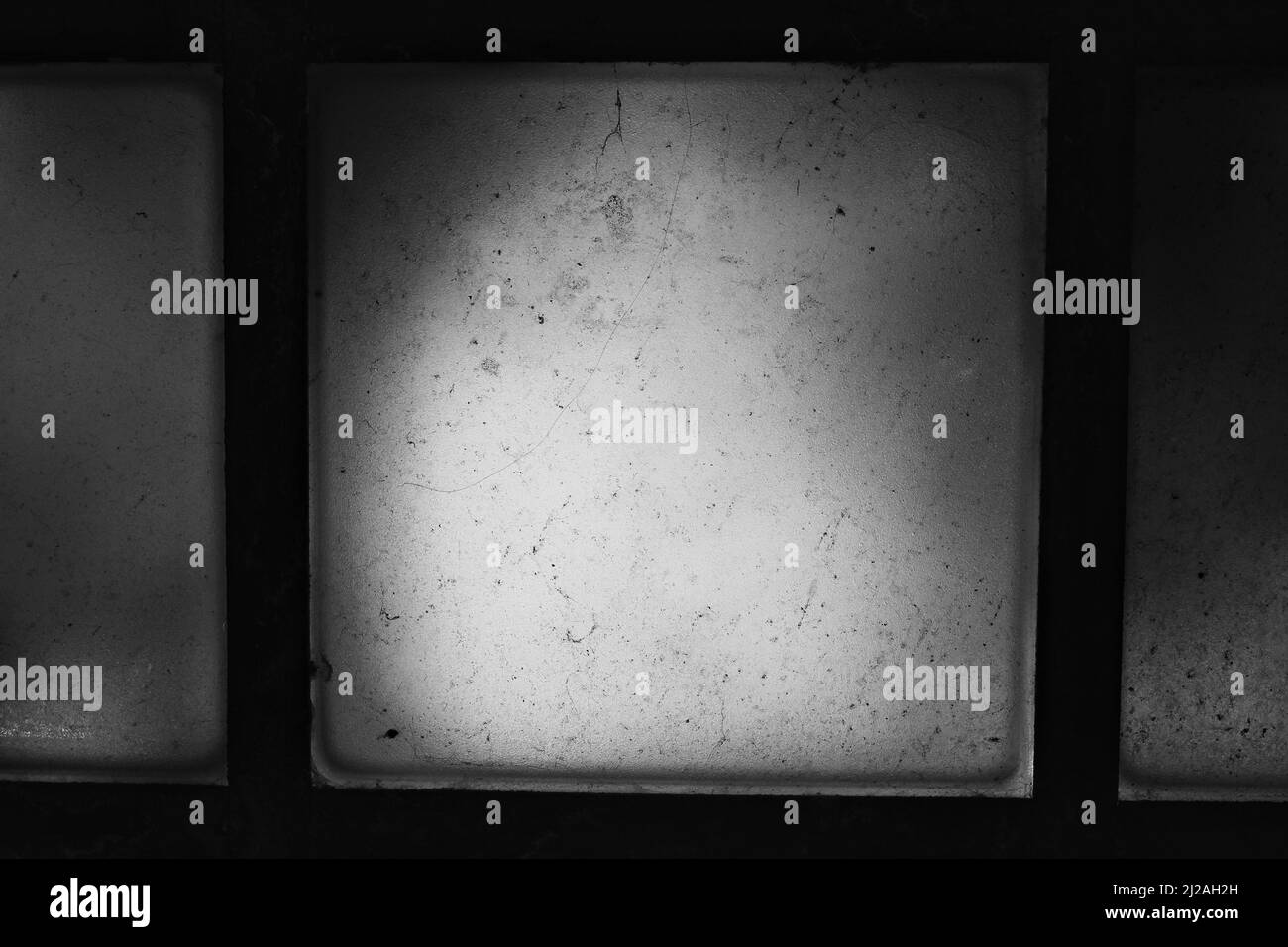 Old worn and stained translucent window with lots of build up of dirt ...