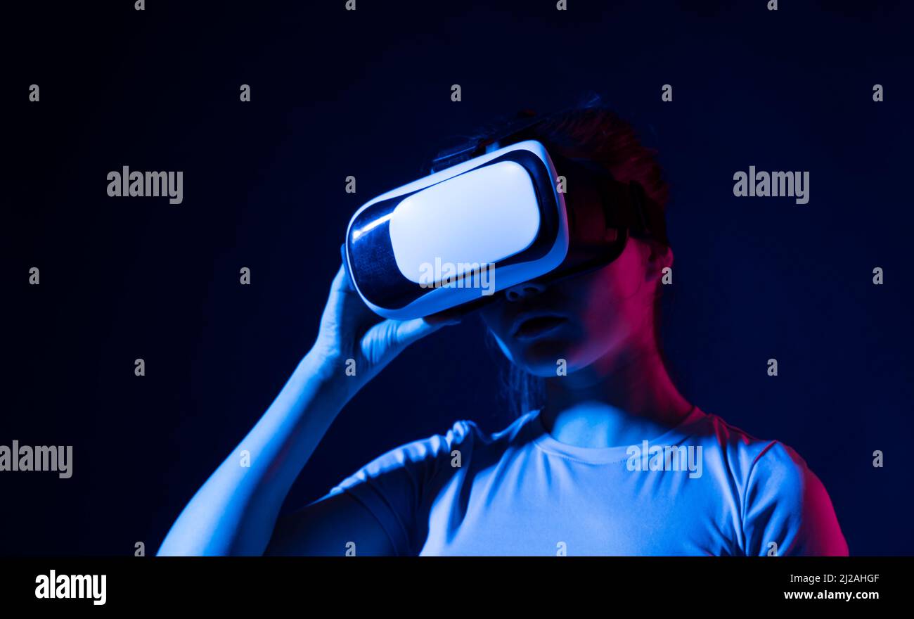 Young woman developer, designer or architector using VR headset to ...