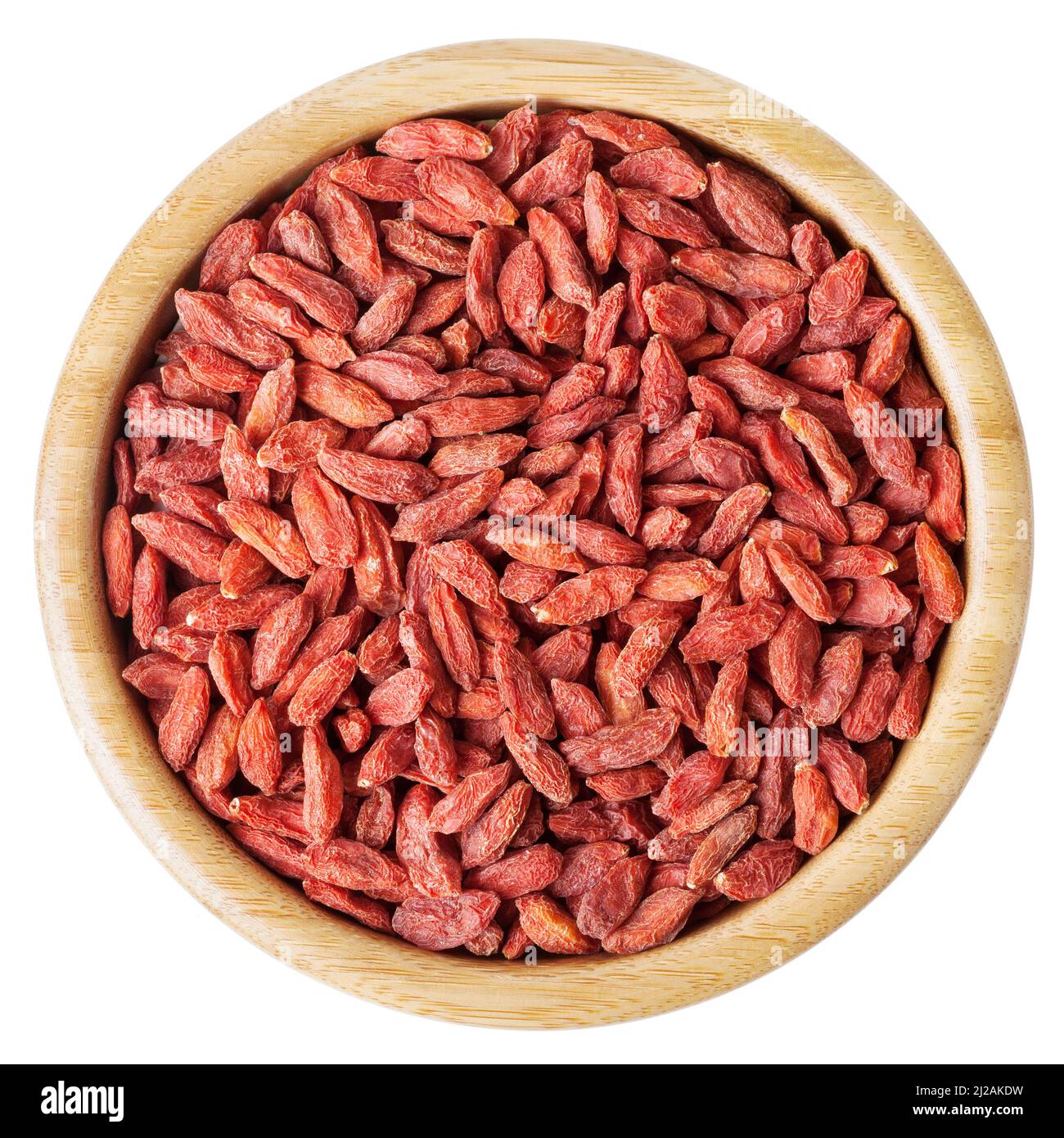 Dried goji berries in wooden bowl isolated on white background with ...