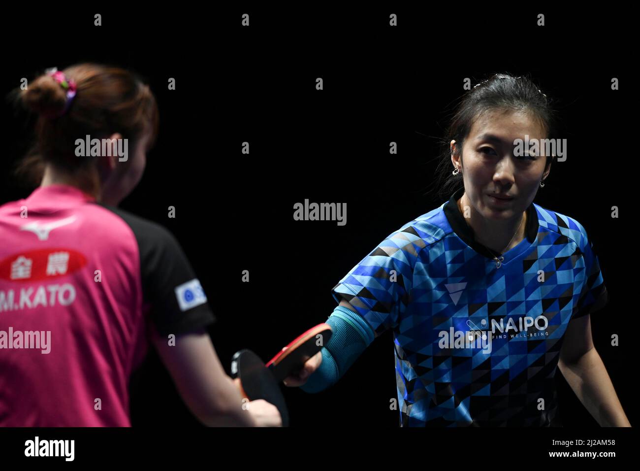 Doha, Qatar. 31st Mar, 2022. Han Ying (R) of Germany greets Kato Miyu ...