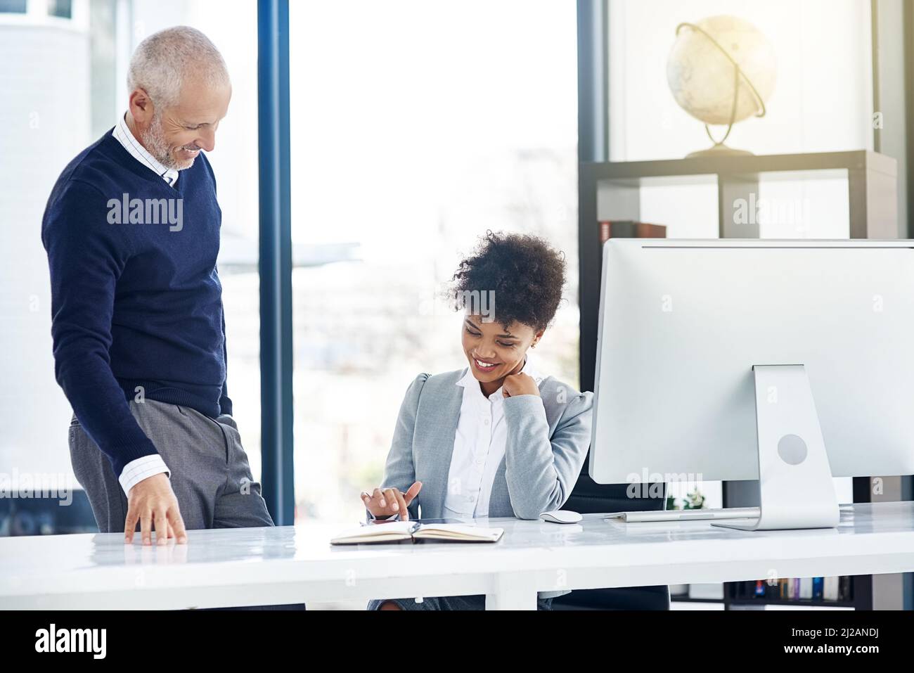 They welcome technology in their office. Shot of two businesspeople ...