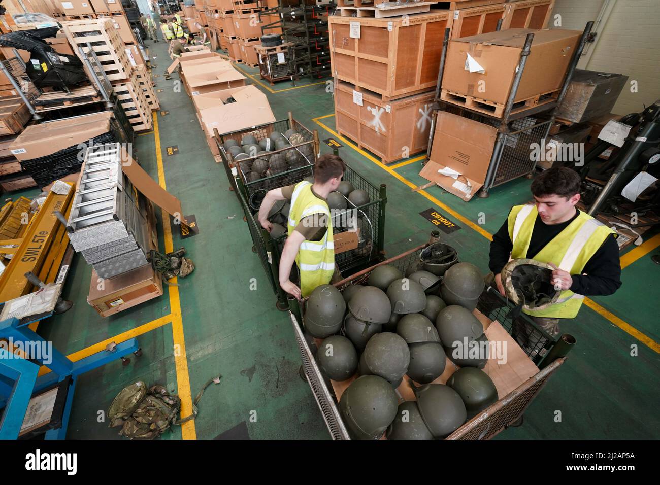 Members of the military pack thousands of surplus helmets donated by ...