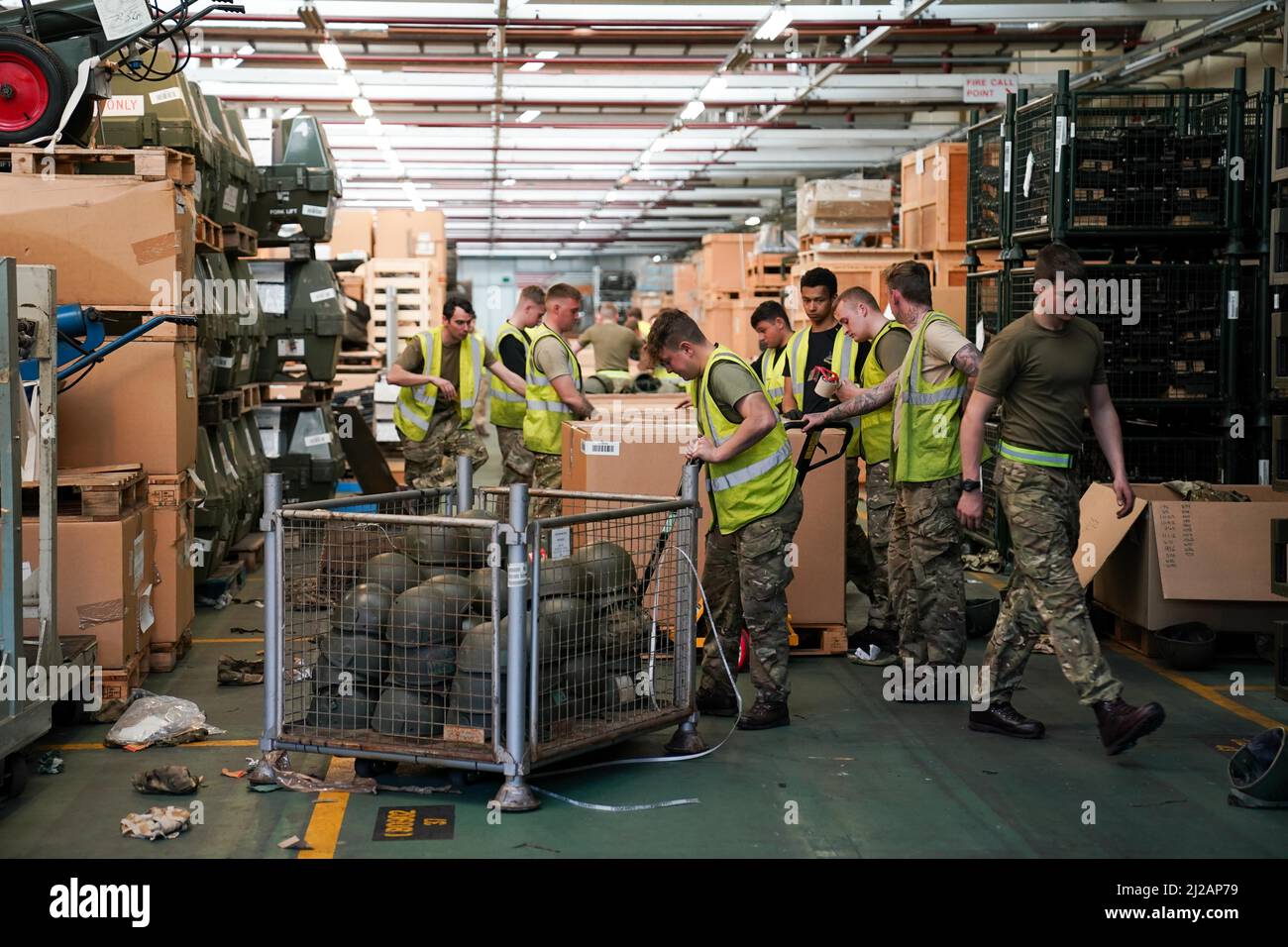 Members of the military pack thousands of surplus helmets donated by ...