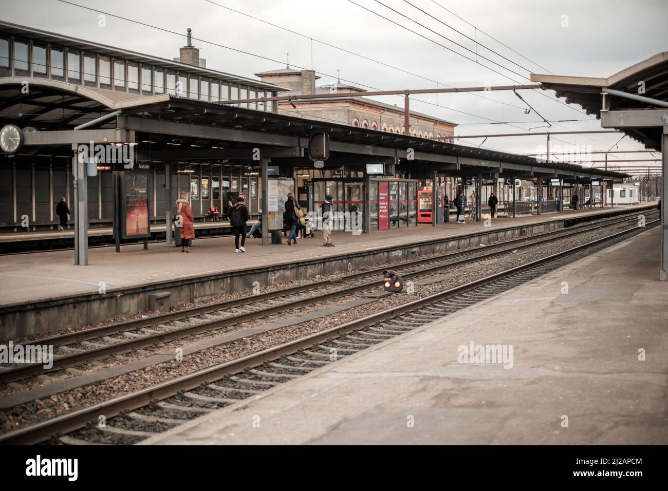 Commuters in Roskilde wait on station platforms for train connecting ...