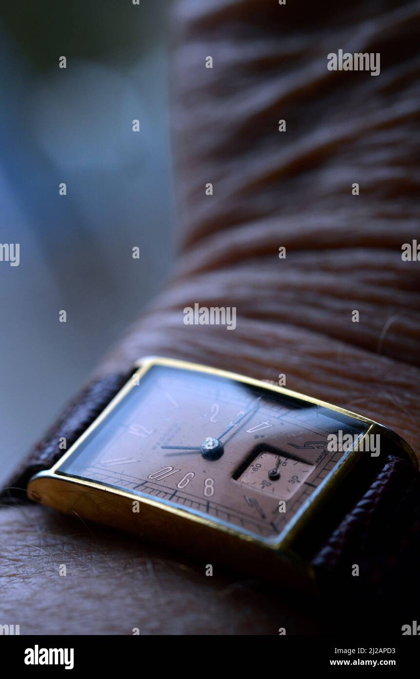 vintage 1930's rectangular record tank watch and wrinkled wrist Stock ...