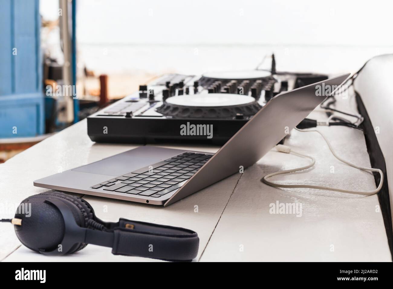 DJ sound control table mixing with headphone and laptop computer on ...