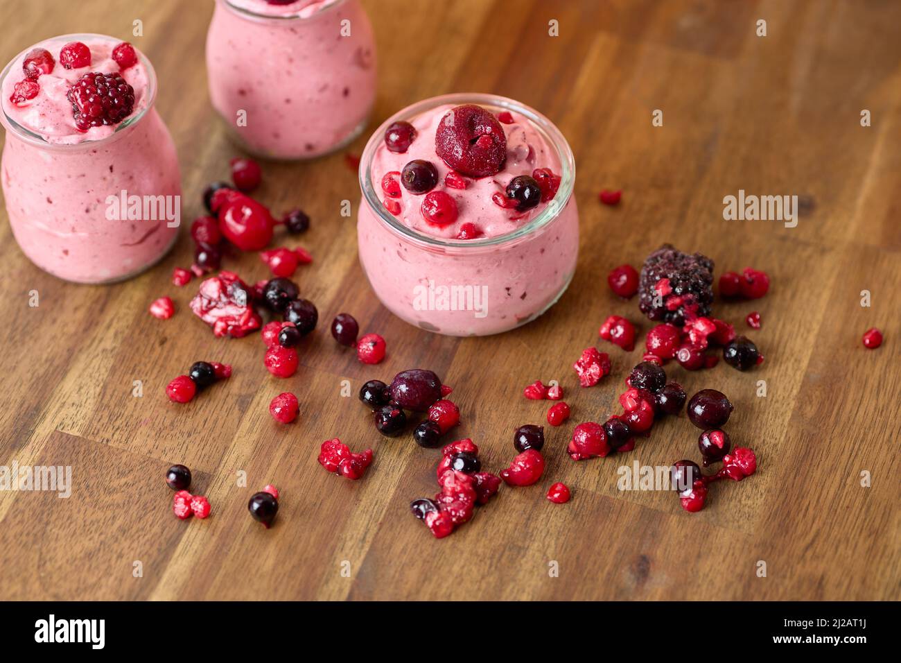 Berries foam dessert in orange and wood background Stock Photo - Alamy
