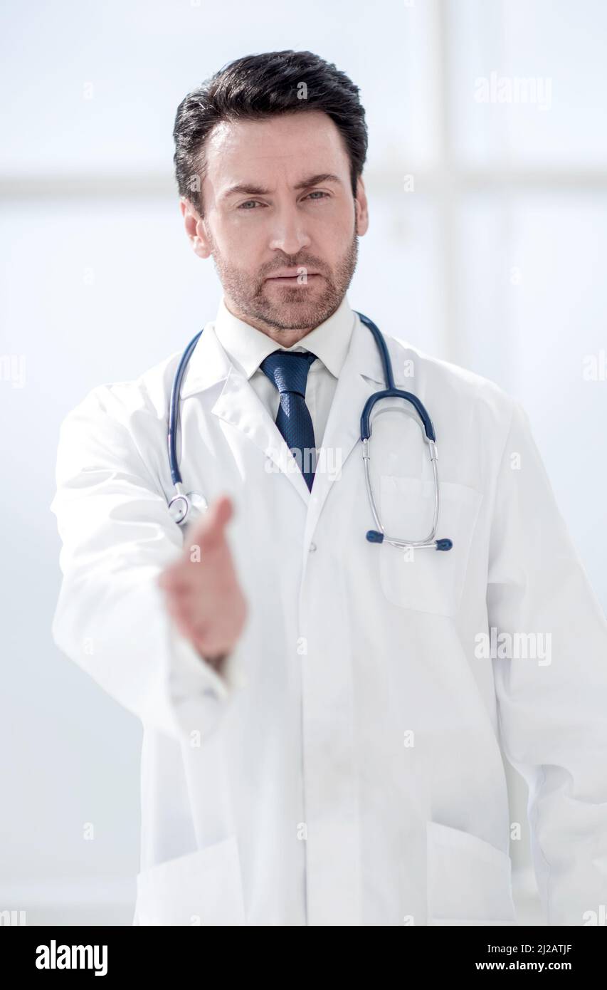 background image of the doctor holding out his hand for greeting Stock ...
