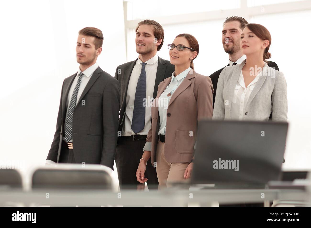 group of employees standing near the desktop Stock Photo - Alamy