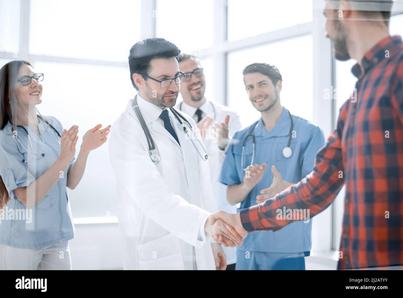 Thankful patient shaking doctors hand Stock Photo - Alamy