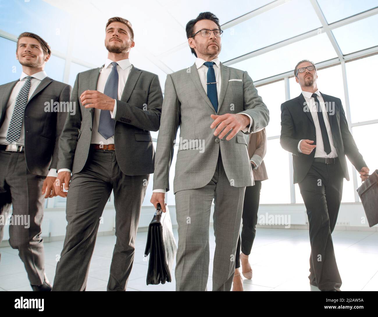 business team, walking at modern office interior Stock Photo - Alamy