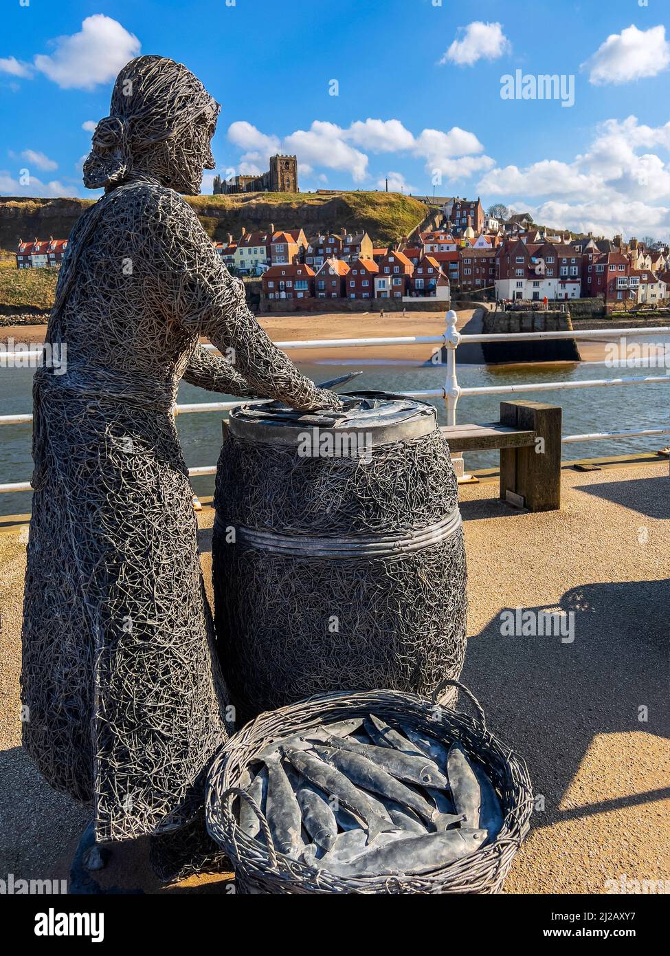Wire statue of a fishwife at the harbor in the port of Whitby on the ...