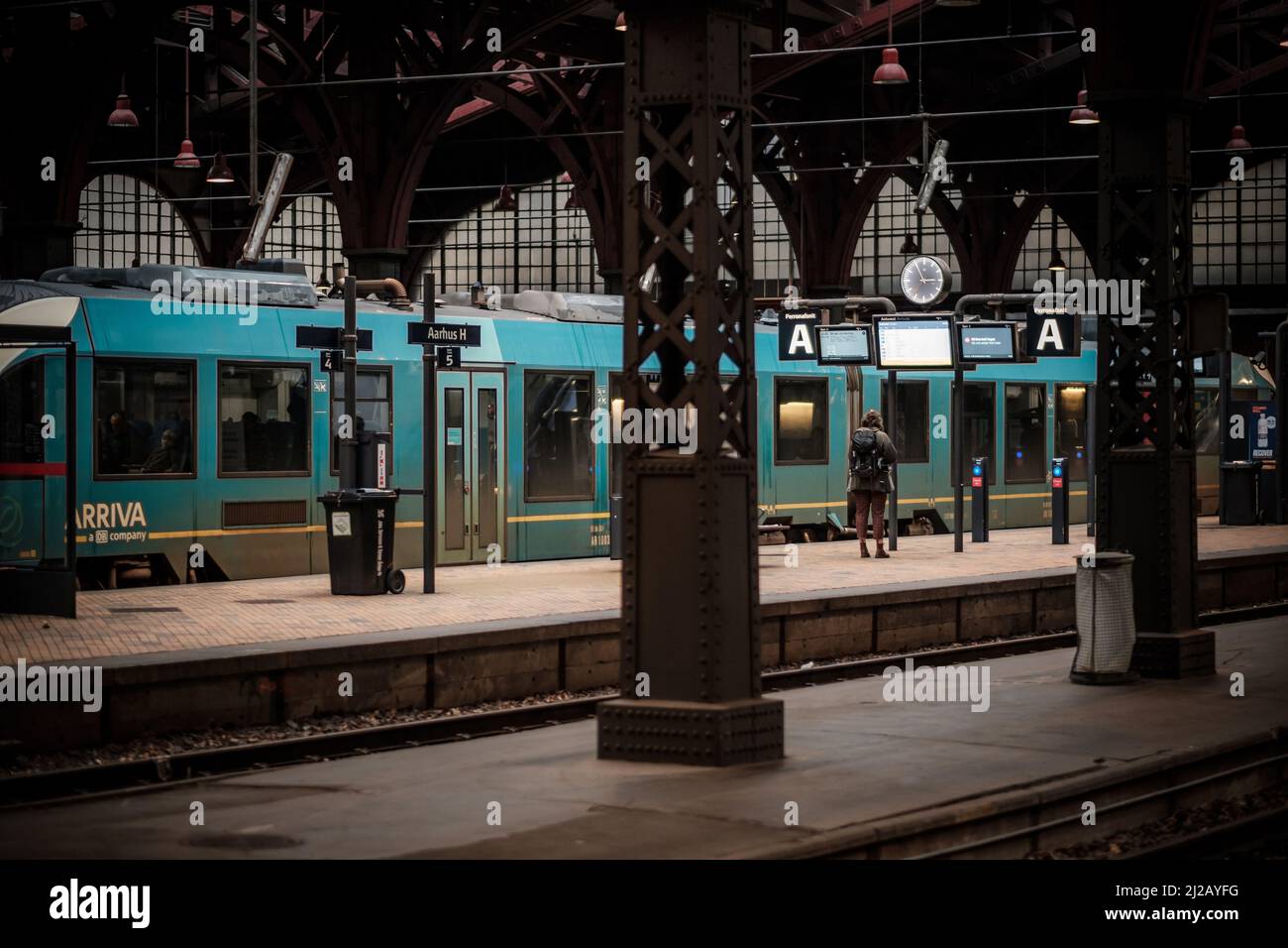 Commuters rush in snow and rain to the central train station in Aarhus ...