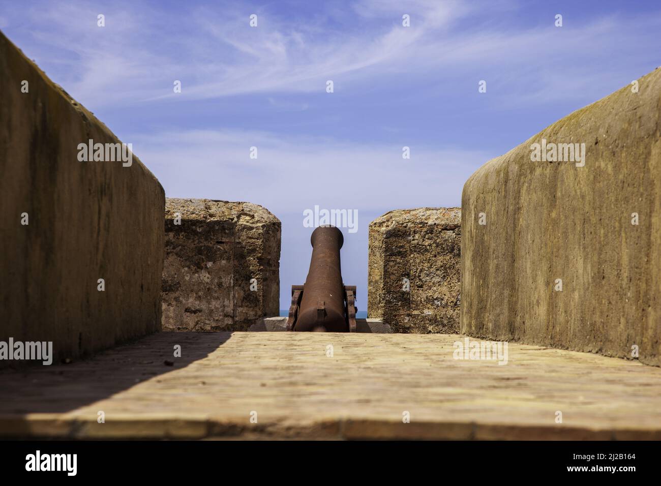 Ancient canon pointing out at the open sea from ancient Asila Fort ...