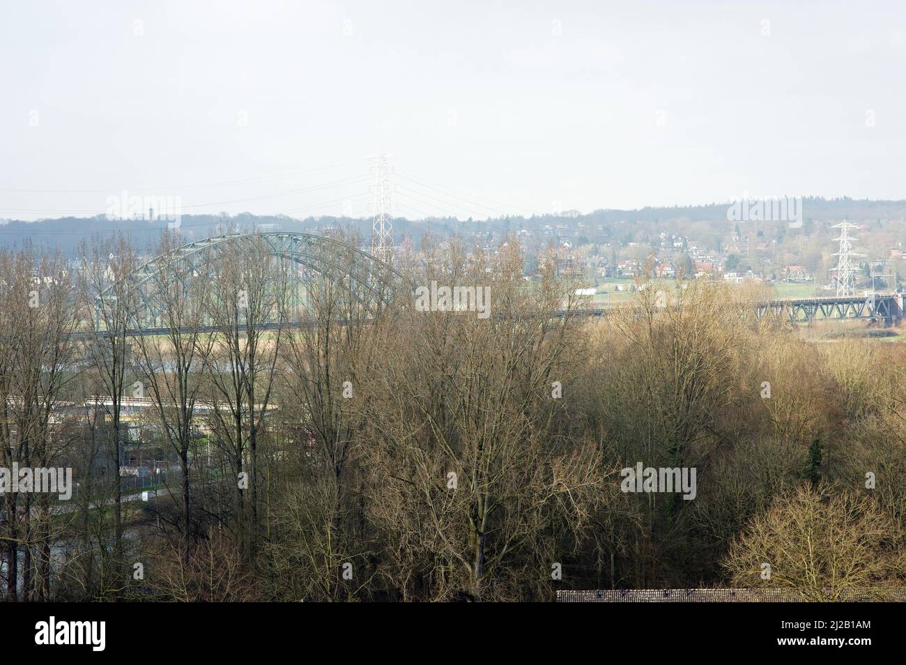 Aerial view of a railway bridge behind trees in Arnhem in the ...