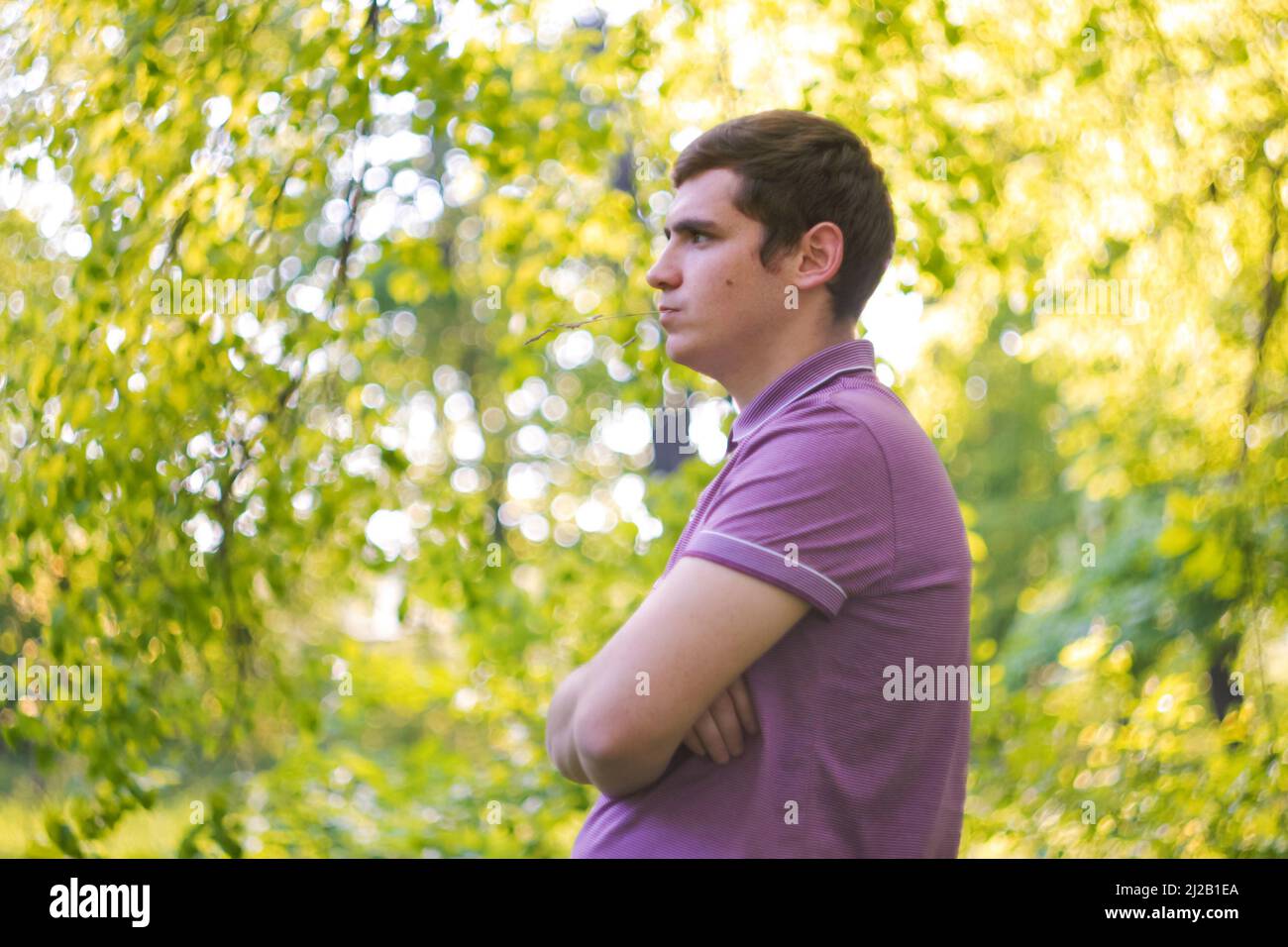Defocus pleasant cheerful handsome young man. Profile view. Nature ...