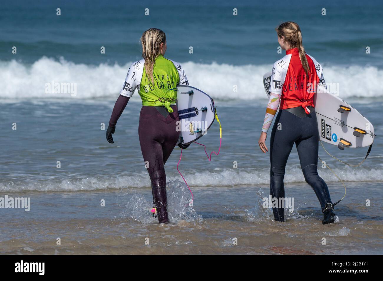 Two female surfers at the start of a surfing competition at Fistral in ...