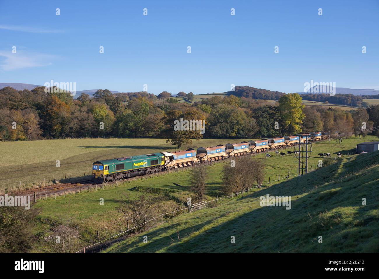 Freightliner class 66 locomotive 66605 hauling a ballast train along ...