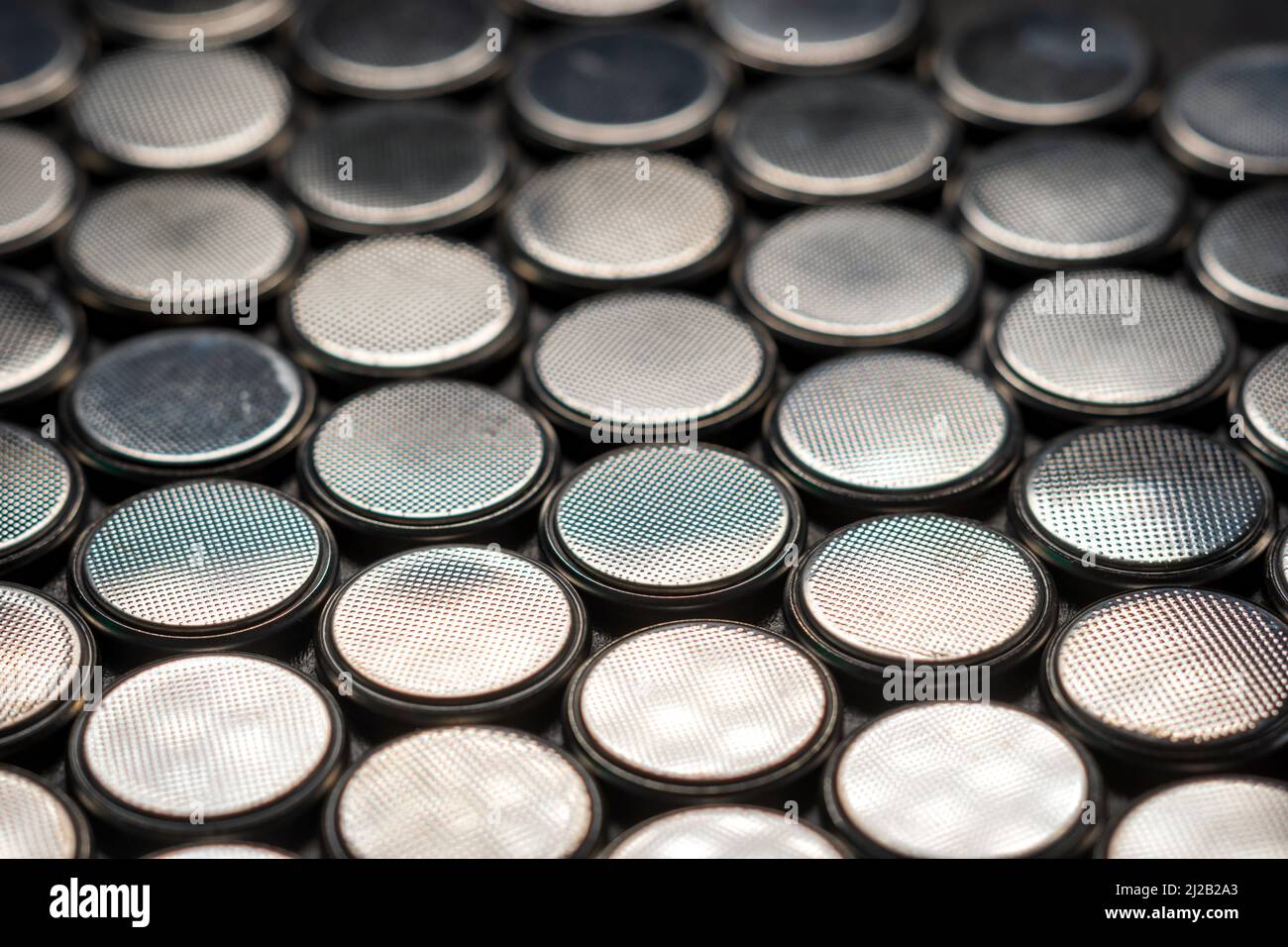 CR2032 coin cell batteries background closeup pan slide Stock Photo - Alamy