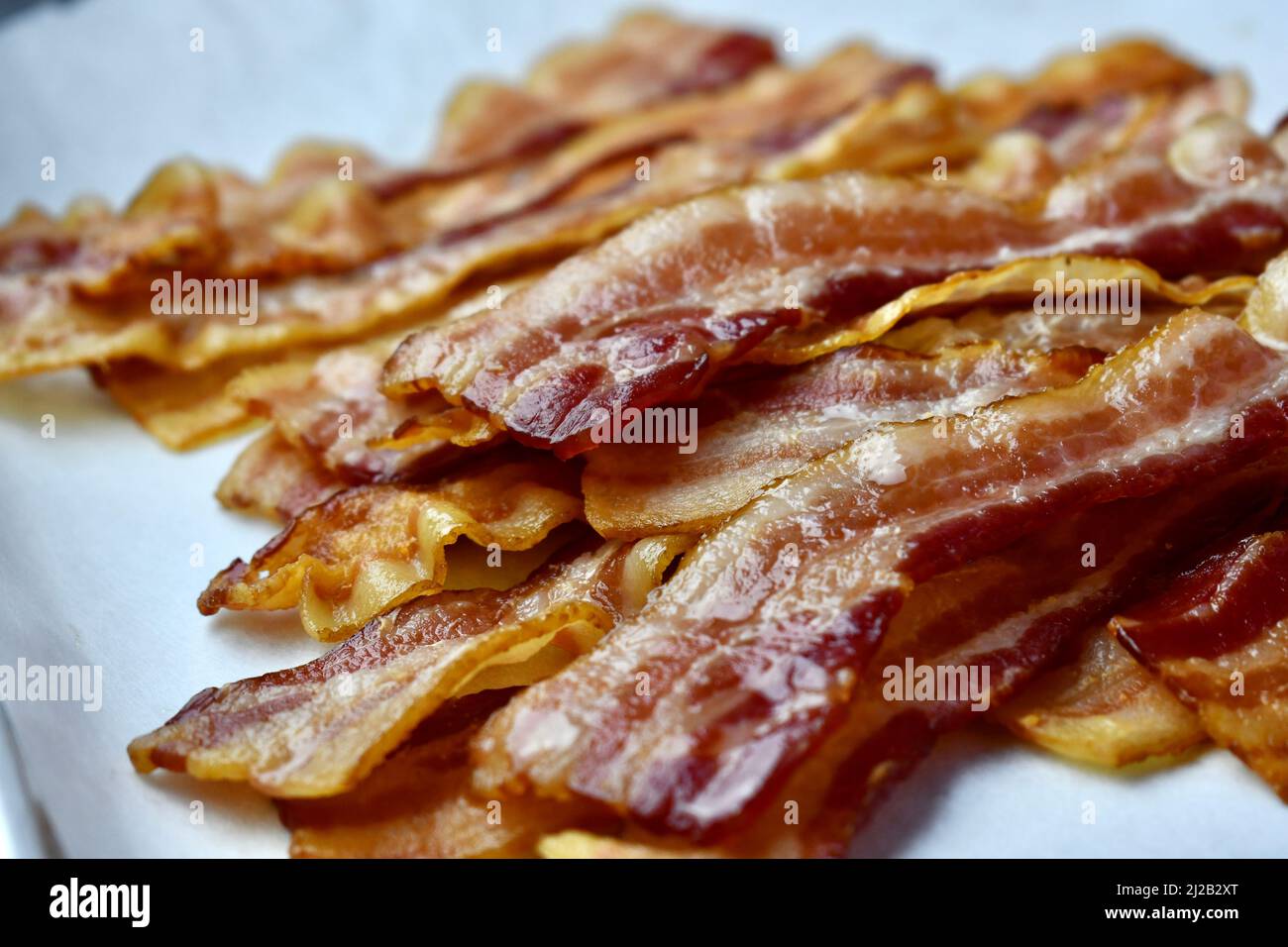 Bacon rashers on parchment lined baking pan Stock Photo - Alamy