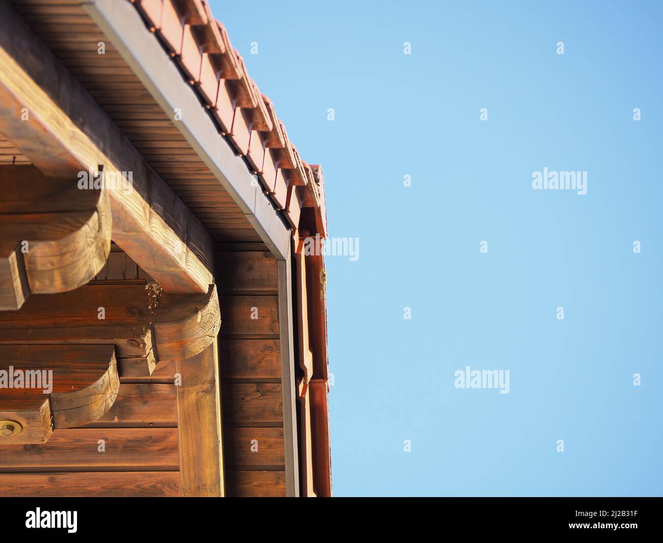 A wooden roof of cozy country house against the blue sky Stock Photo ...