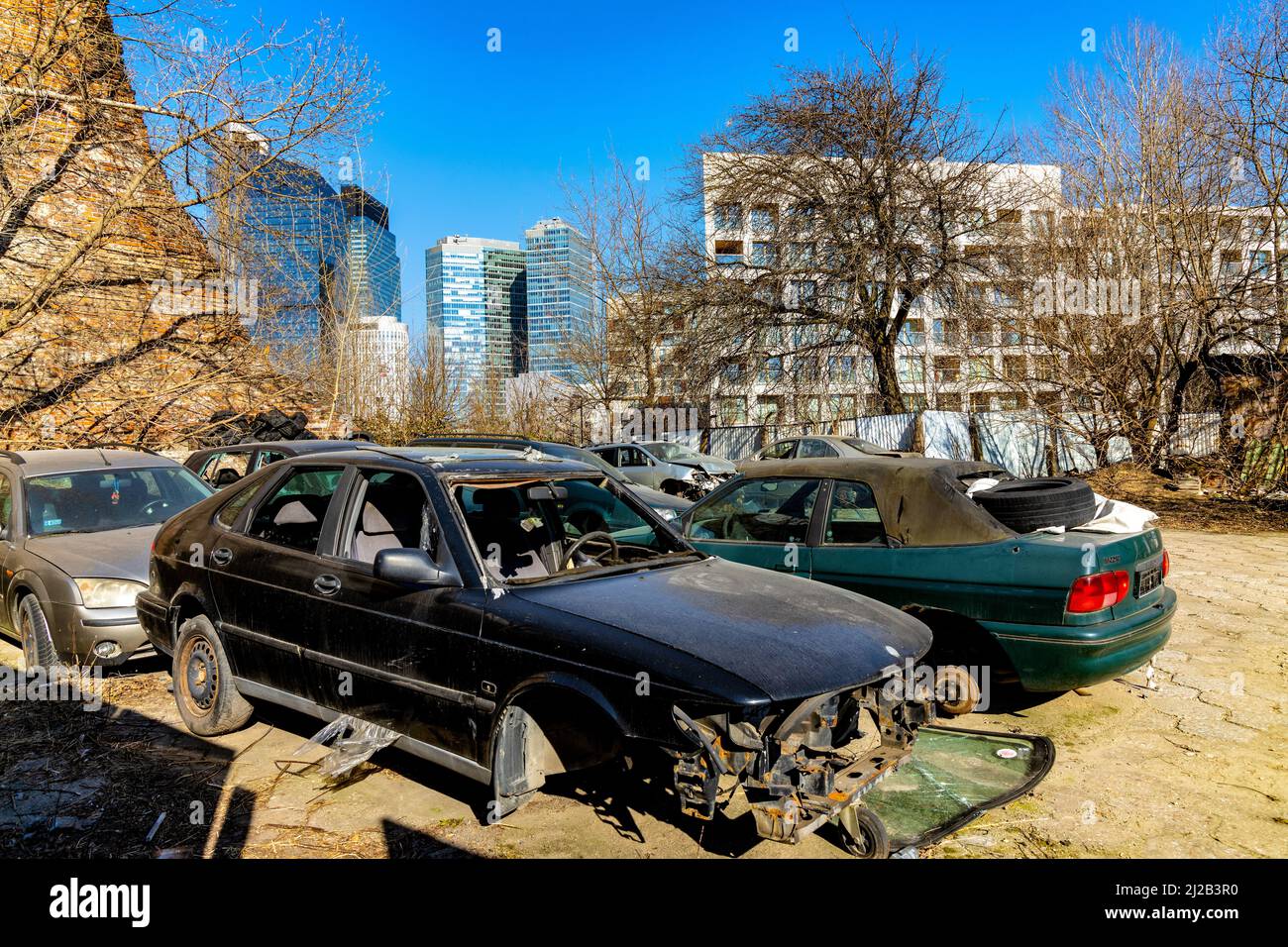 Warsaw, Poland - March 18, 2022: Wreck cars scrapyard with skyscrapers ...