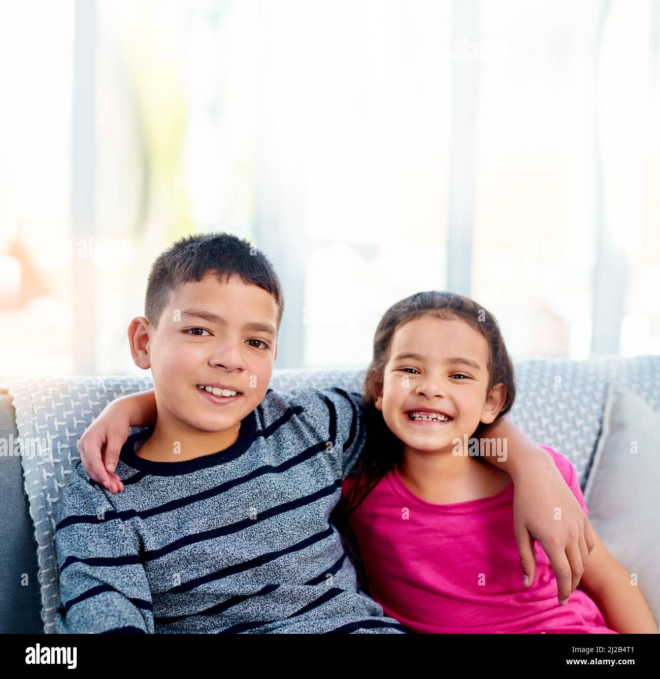 Were closer than you think. Portrait of two adorable young siblings ...