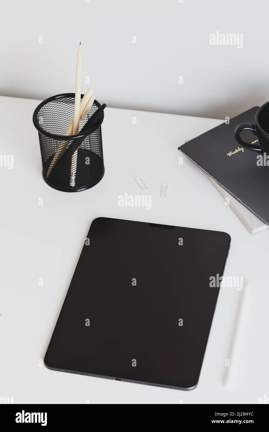 Digital tablet on office desk table with stationery top view. Modern ...