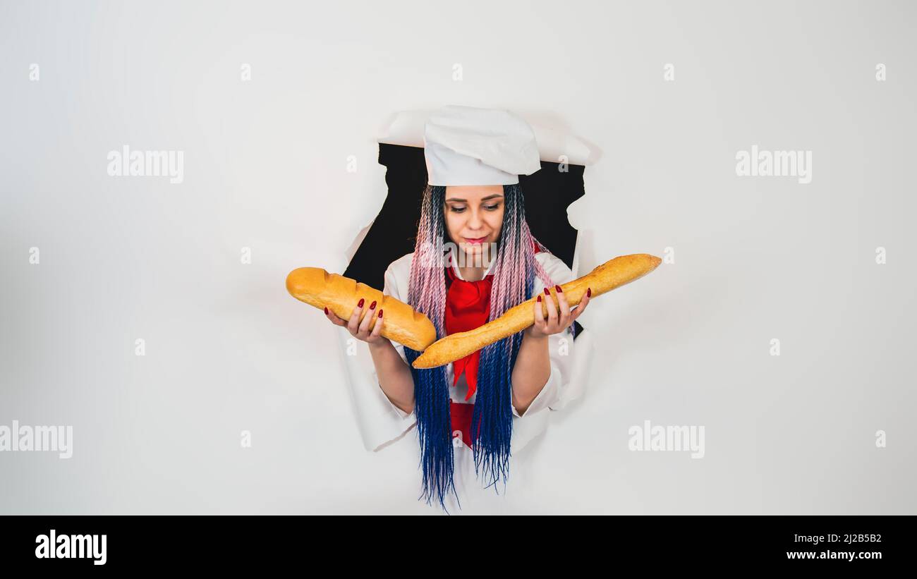 Female cook with loaf in hole of white background Stock Photo - Alamy