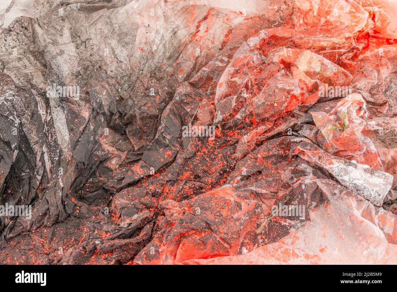 Crafter or artists dust sheet covered by flaking, sprayed, orange and ...