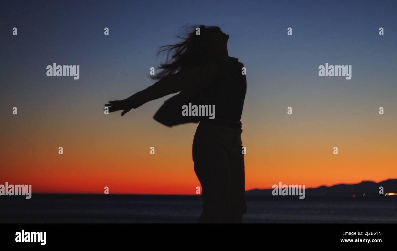 silhouette of carefree dancing girl at sunset Stock Photo - Alamy