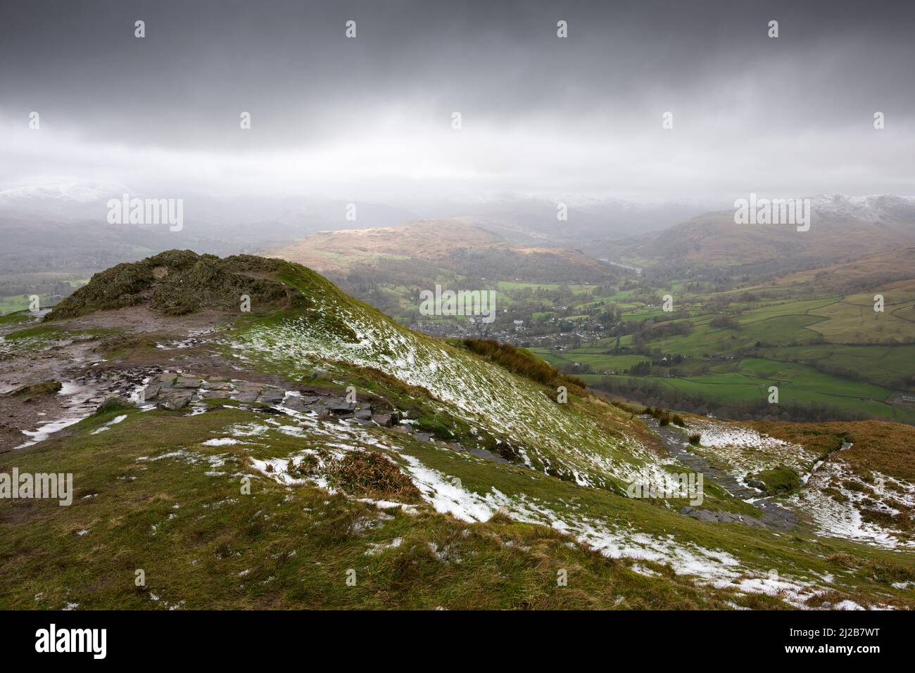 Wansfell Pike in late winter with Ambleside below in the Lake District ...