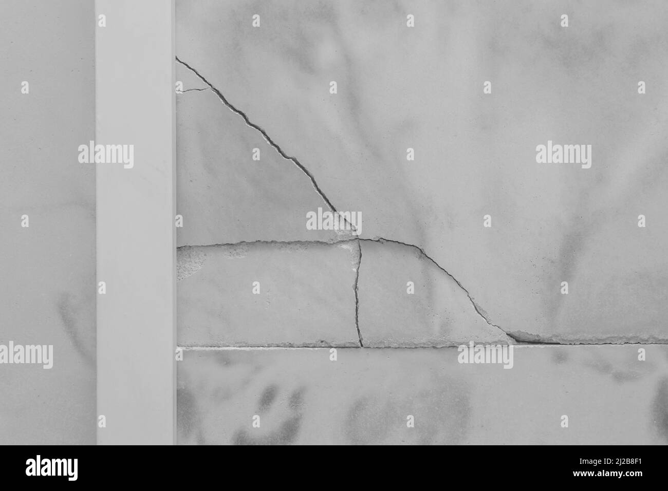 Broken cracked damaged stone tile wall surface in need of repair old ...